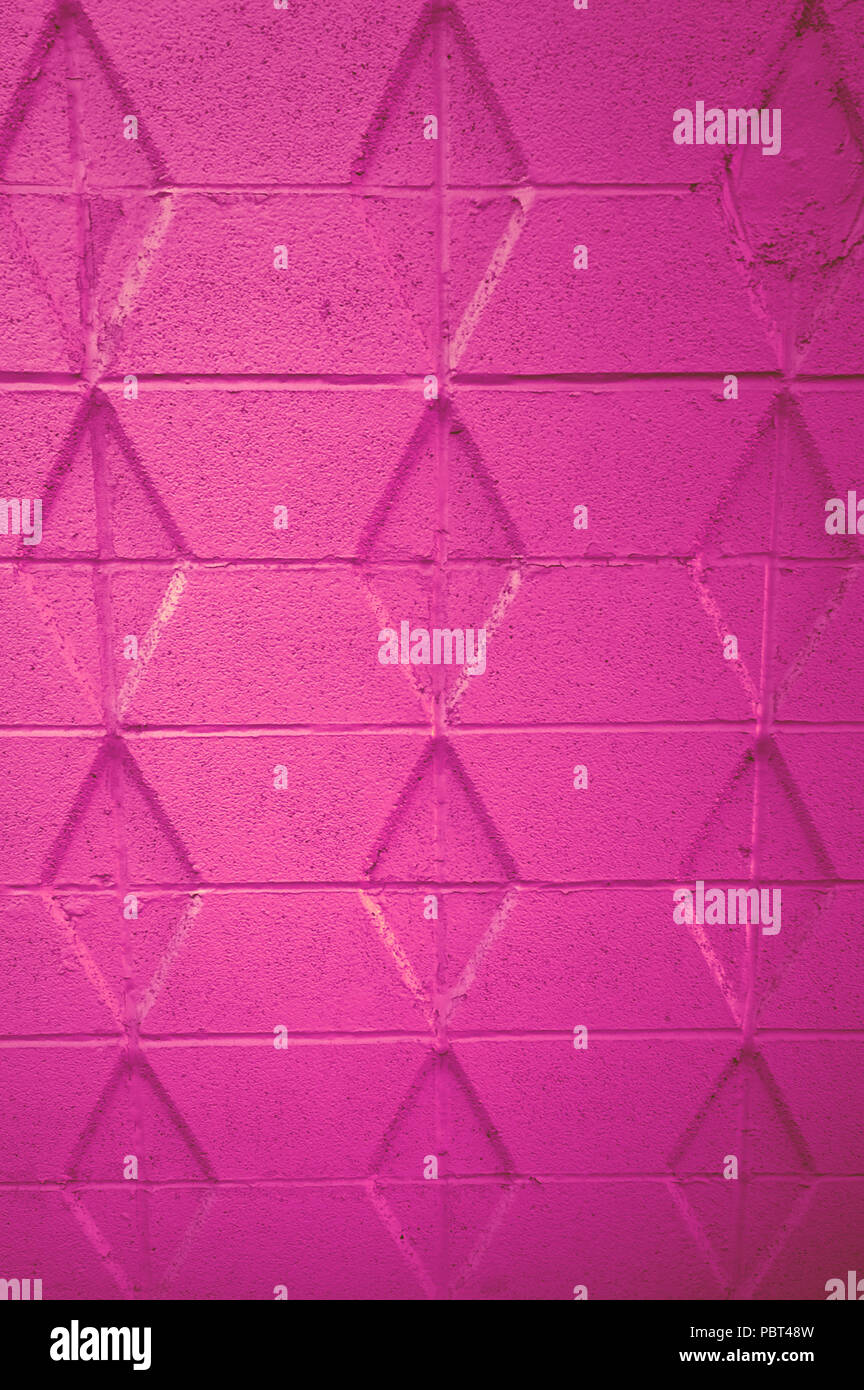 Bright pink concrete wall with diamond pattern Stock Photo - Alamy