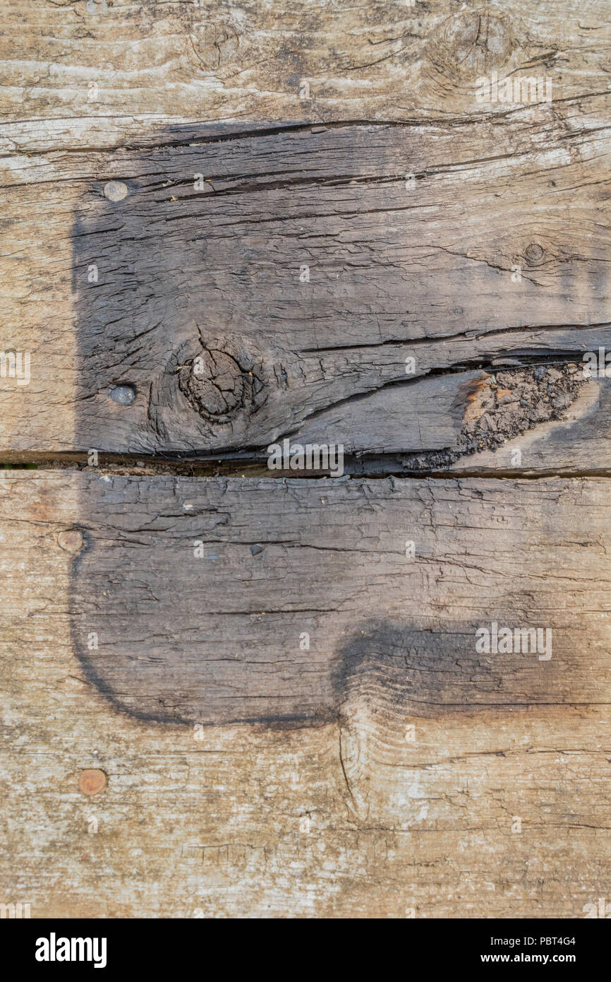 Scorch mark where some hot metal object has been placed on an old ...