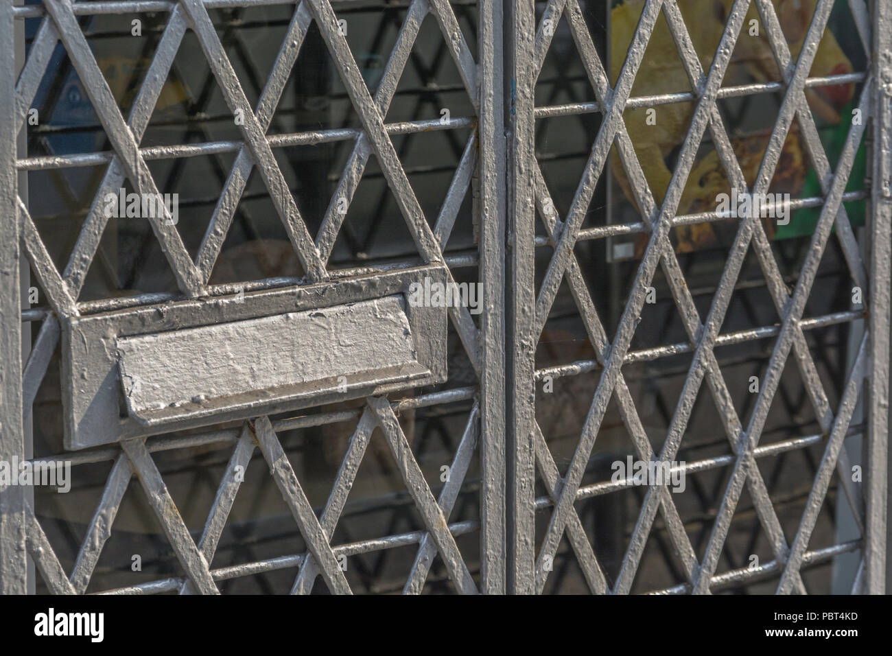 Mouth of letter box in shop window / entrance grille / high street ...