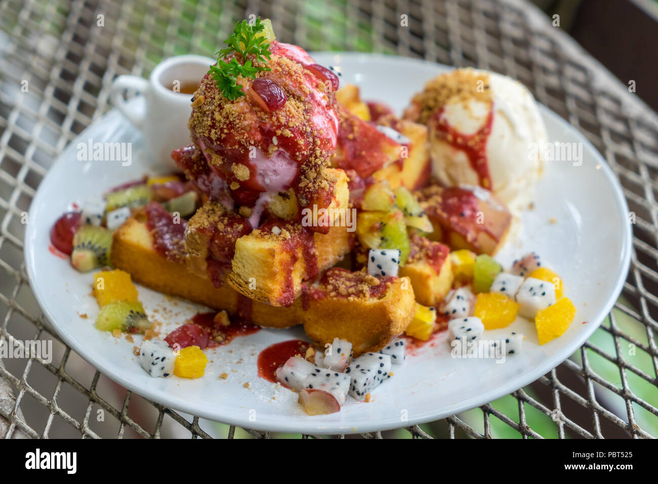 Dessert plate of Honey toast with ice cream Vanilla, mixed fresh sliced ...