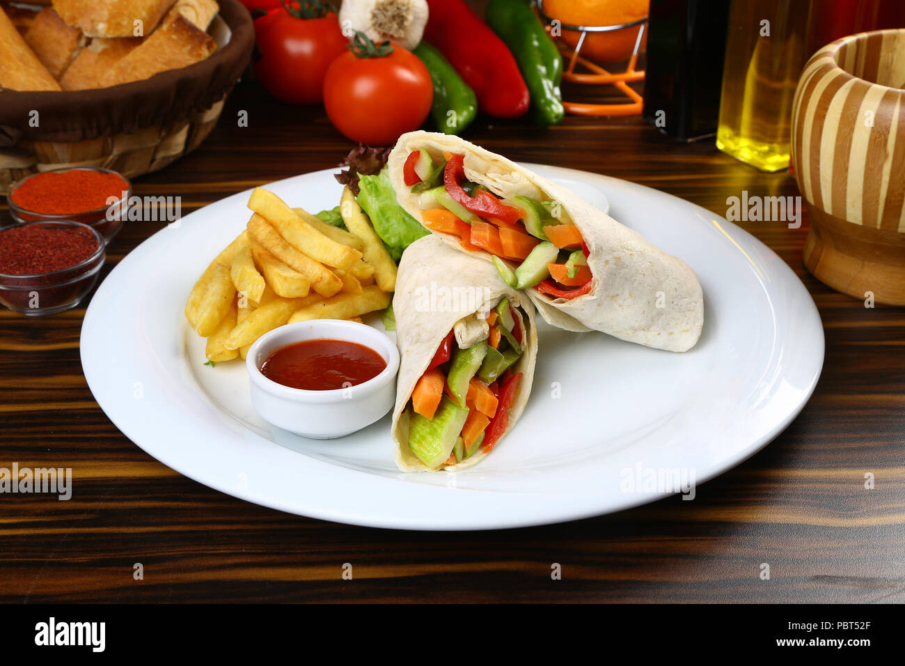 Fried chicken stuffed tortilla wrap sandwich with vegetables and french ...