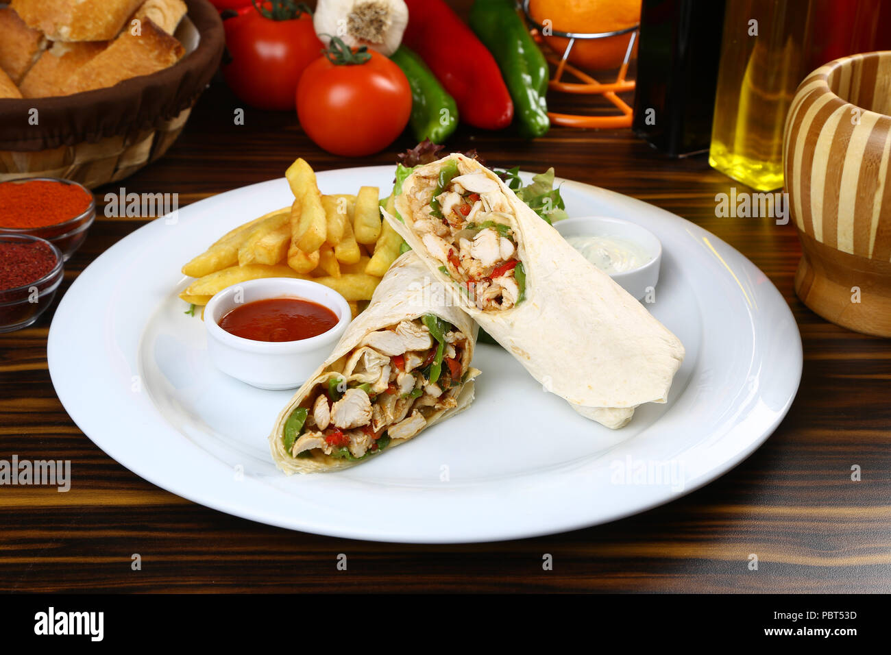 Fried chicken stuffed tortilla wrap sandwich with vegetables and french ...