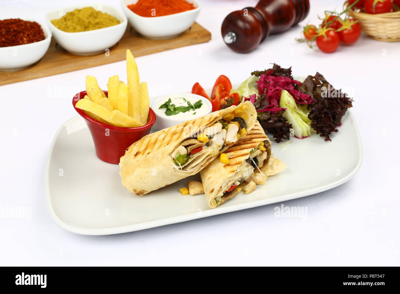Fried chicken stuffed tortilla wrap sandwich with vegetables and french ...