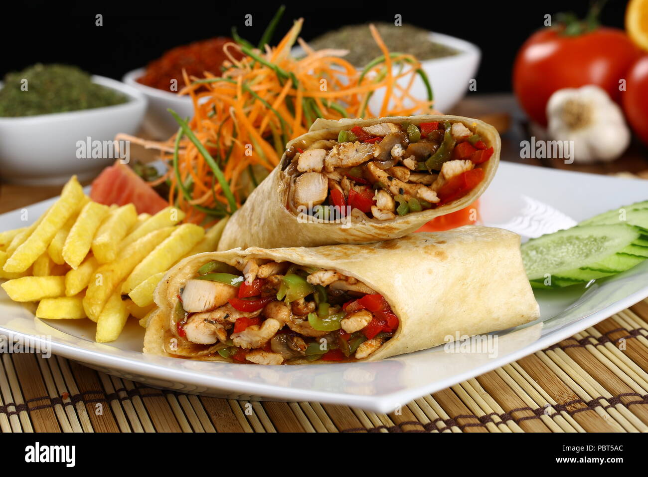 Fried chicken stuffed tortilla wrap sandwich with vegetables and french ...