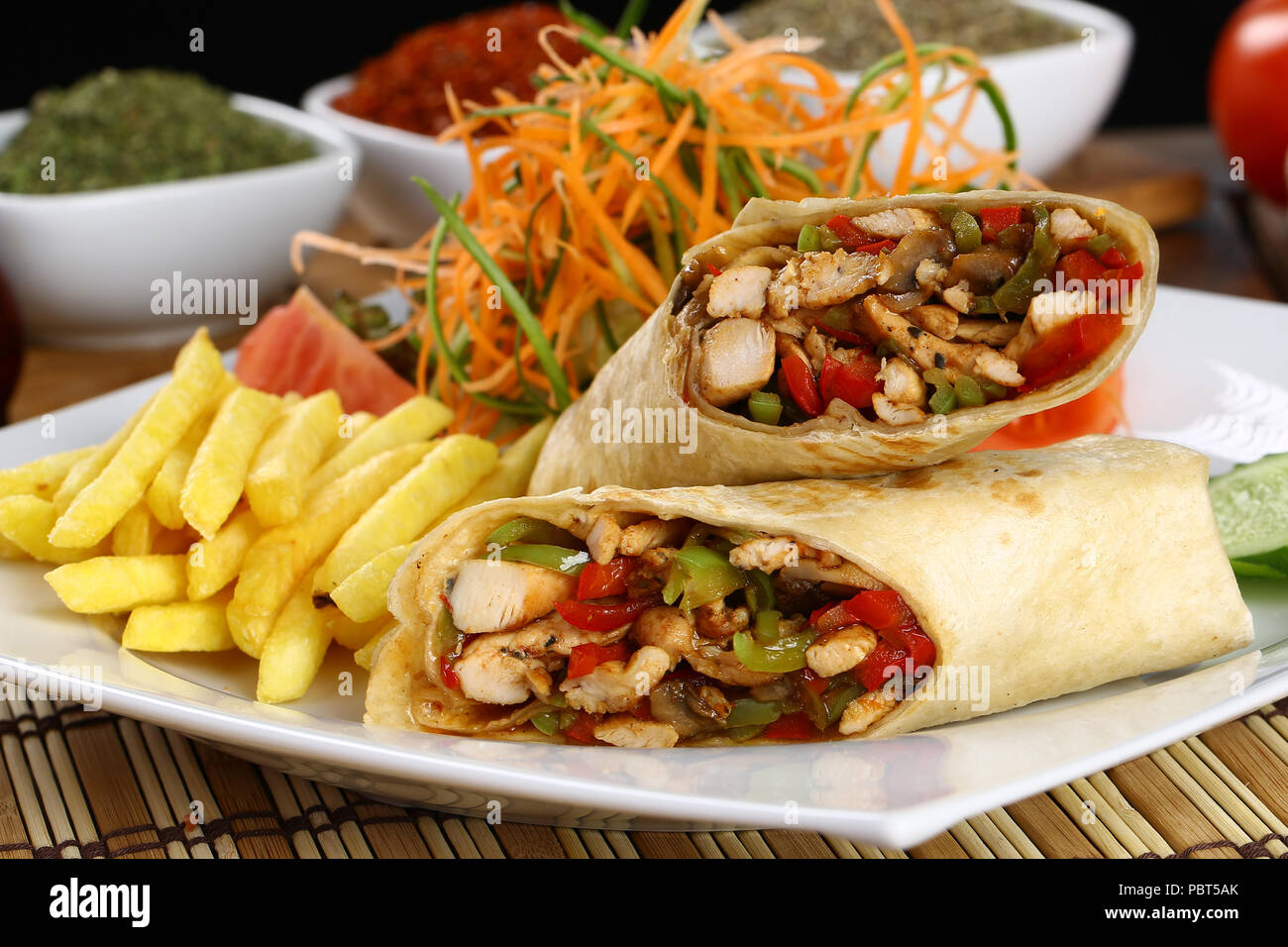 Fried chicken stuffed tortilla wrap sandwich with vegetables and french ...