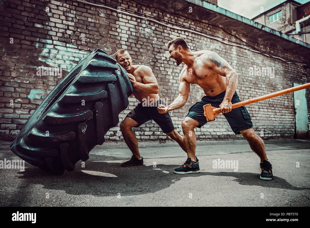 Two muscular athletes training. Muscular fitness shirtless man moving ...