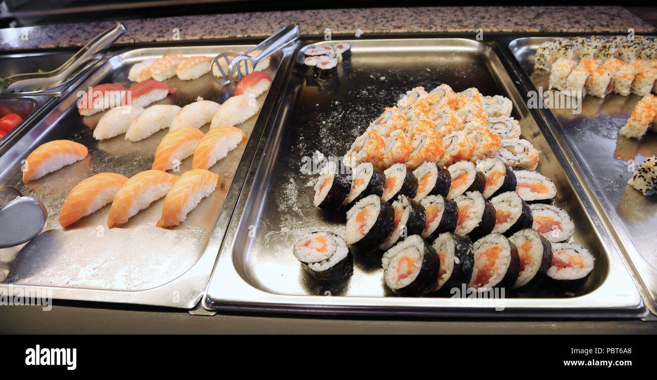 sushi of different qualities on the trays of a Japanese self-service ...