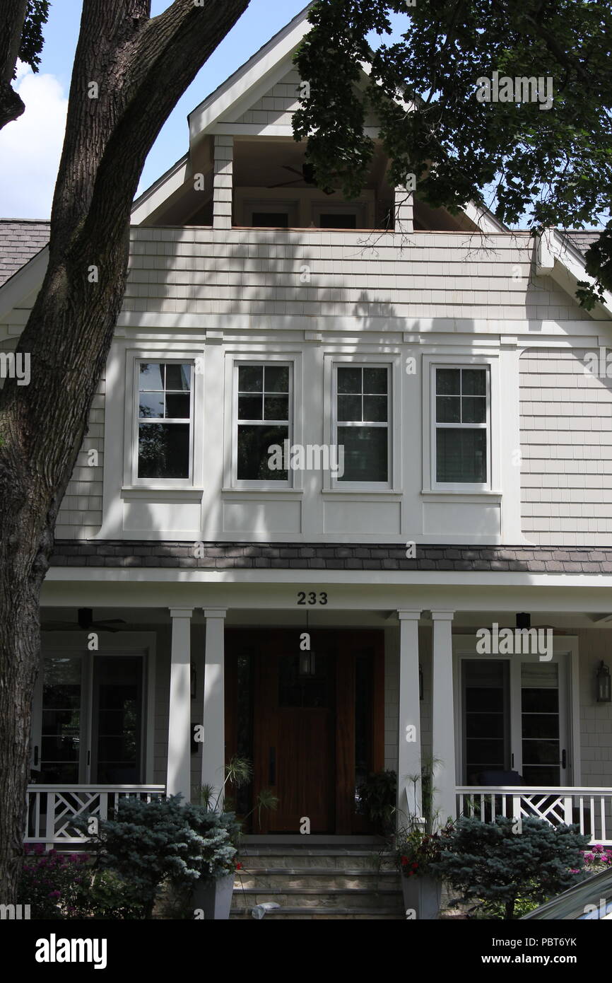 Cute white wooden house with a front porch Stock Photo - Alamy