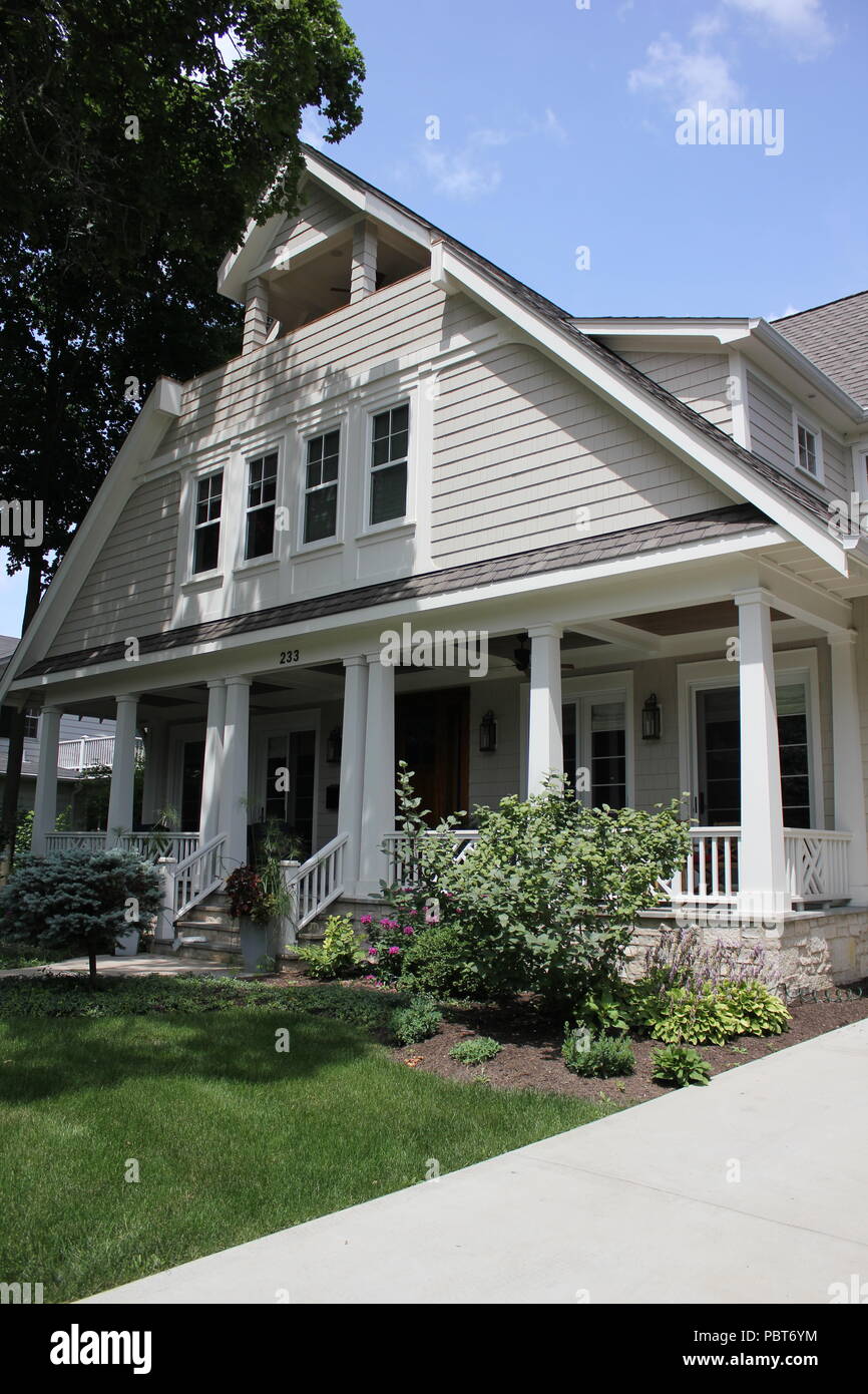 Cute white wooden house with a front porch Stock Photo - Alamy