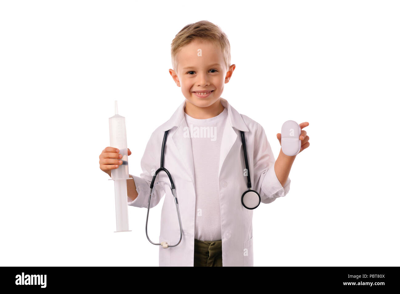 A little, smiling boy doctor in medical uniform, isolated on white ...