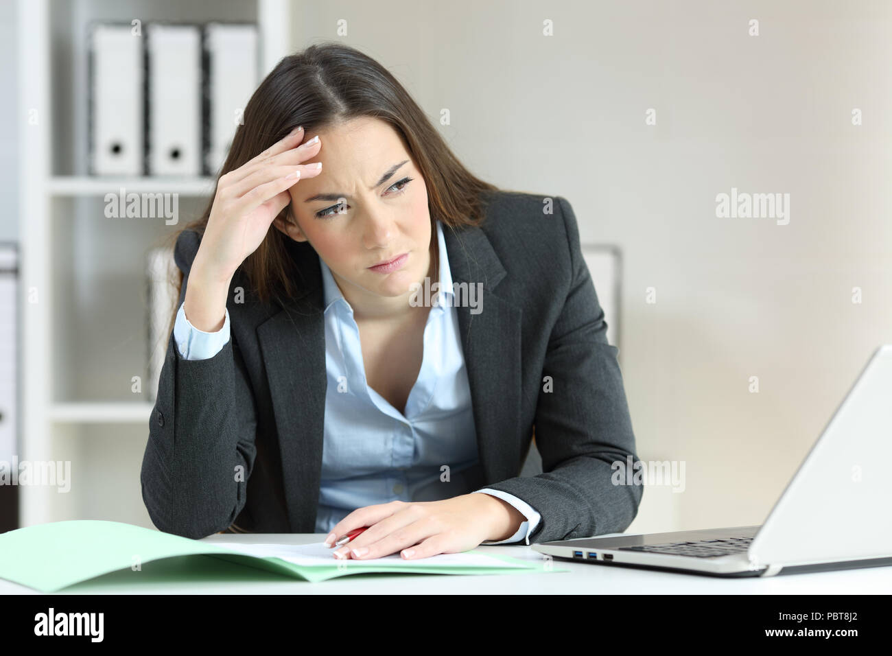 Front view portrait of a worried office worker looking at side Stock ...