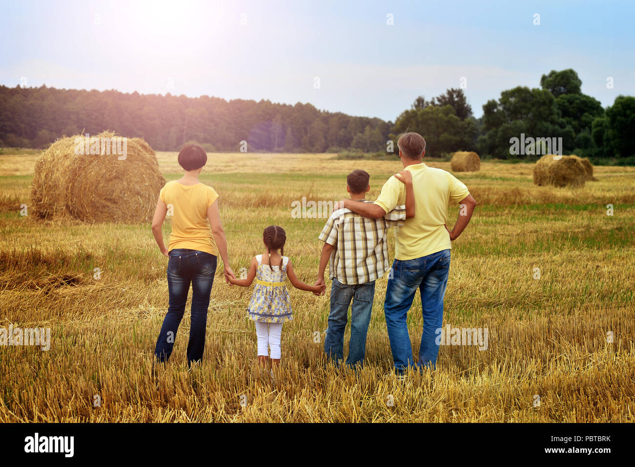 Happy family in wheat field Stock Photo - Alamy