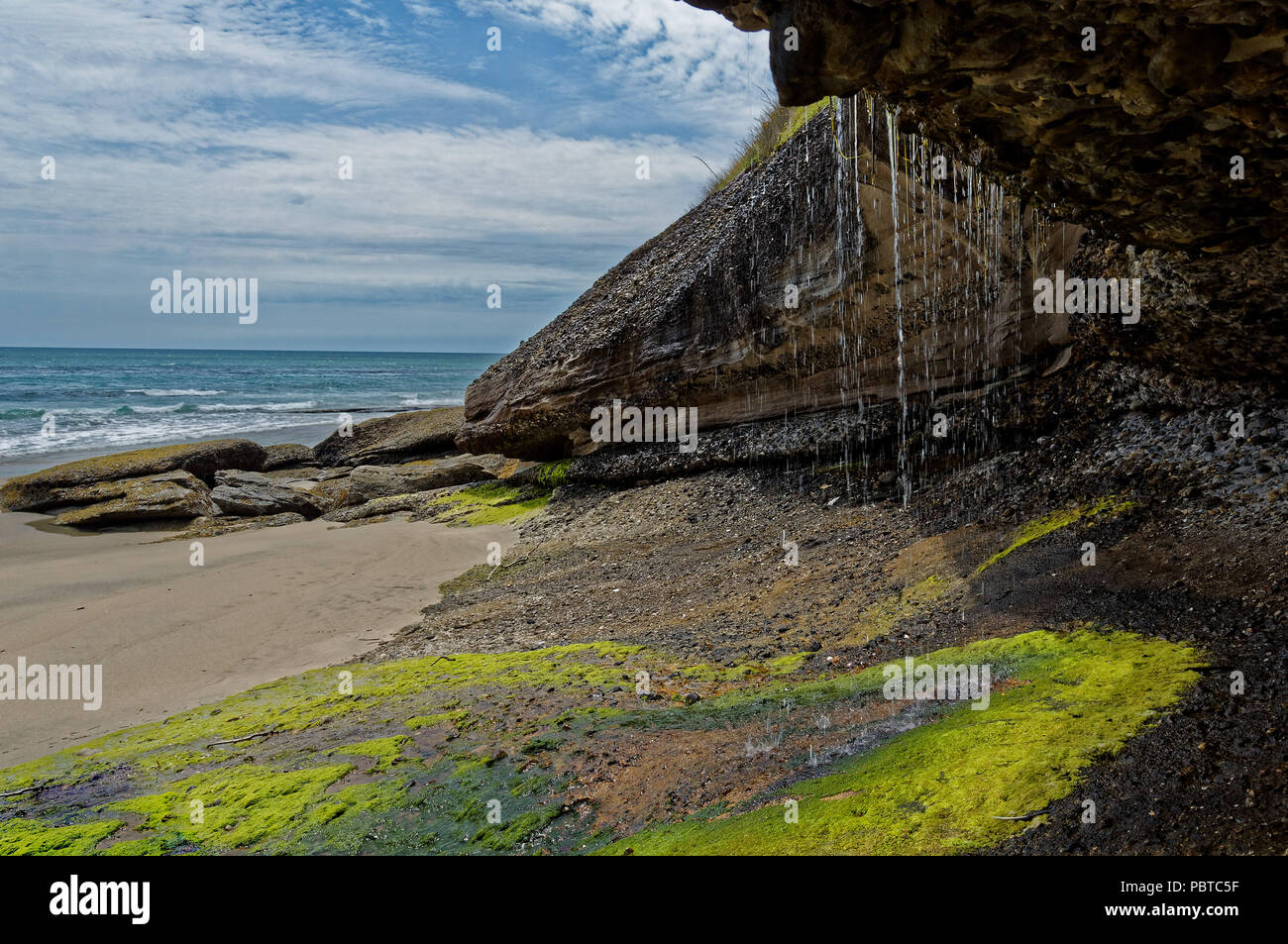 Water running over a small rocky outcrop Stock Photo - Alamy