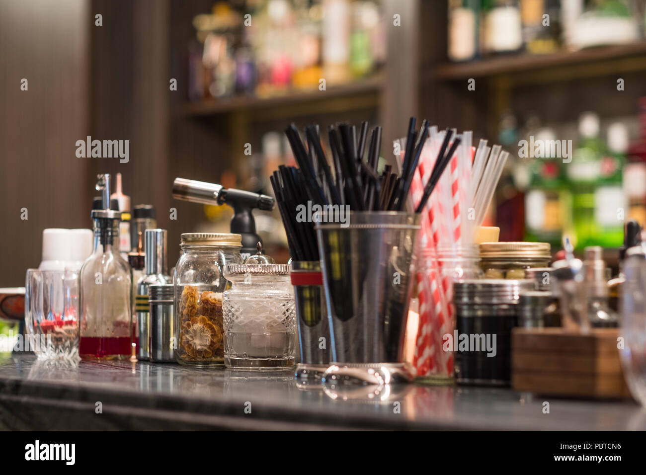 Professional cocktail tools and ingredients in glass bottles and jars ...