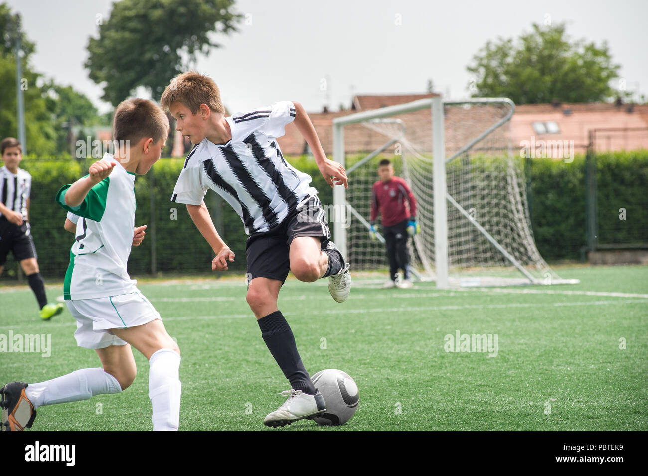 boys kicking football on the sports field Stock Photo - Alamy