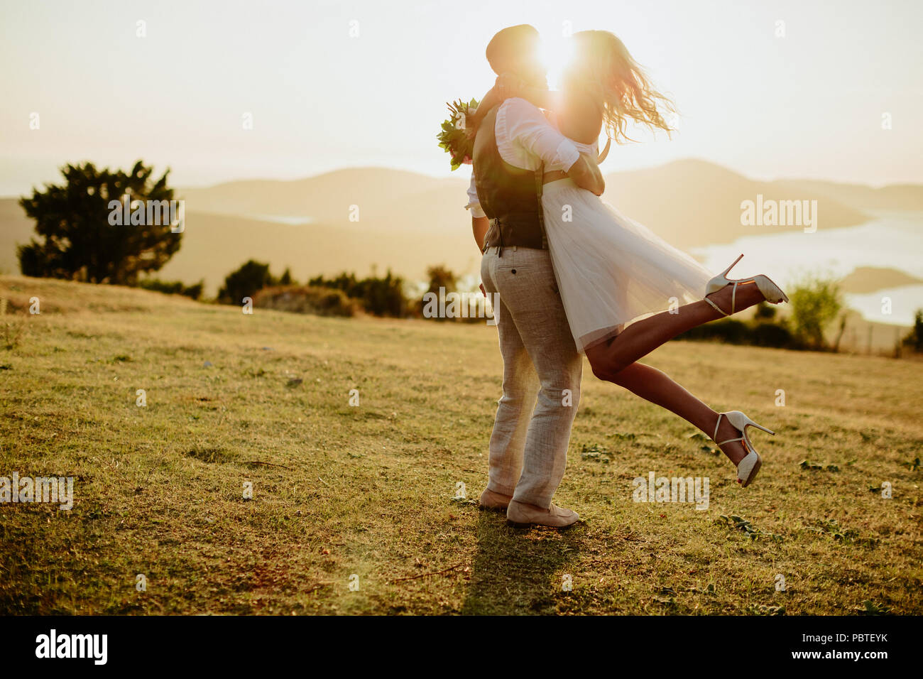 couple happy dance at sunset. Wedding couple with wind in hair. Airy ...