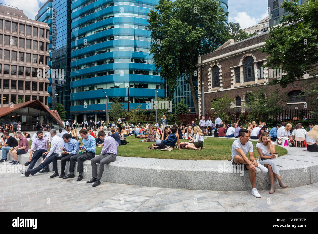Local office workers and tourists enjoying a sunny Lunchtime break in ...