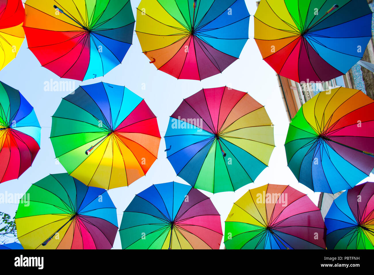 Multi-colored umbrellas background. Colorful umbrellas floating above ...