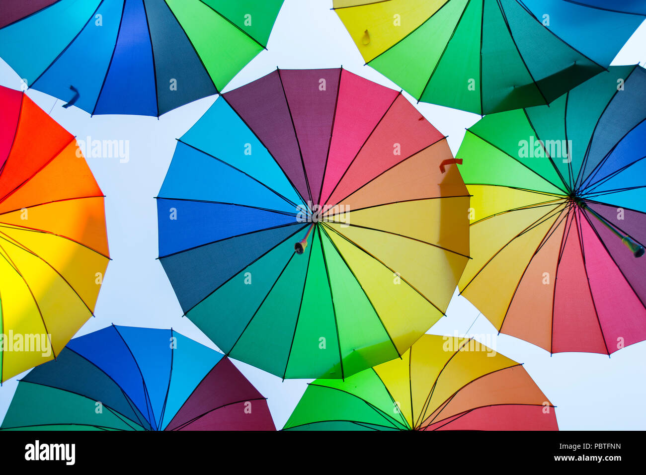 Multi-colored umbrellas background. Colorful umbrellas floating above ...