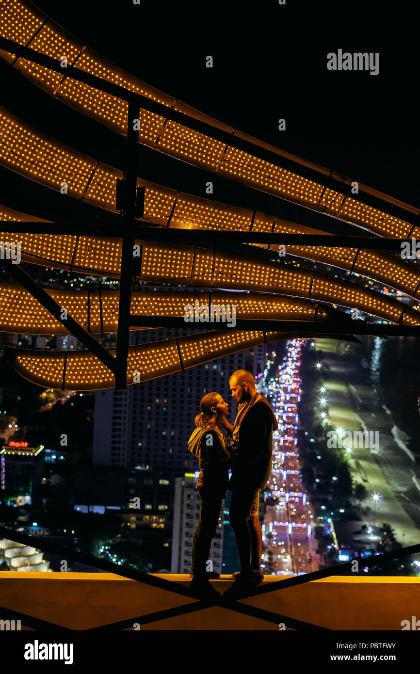 Romantic date on the roof. Loving couple dating on the roof at night ...