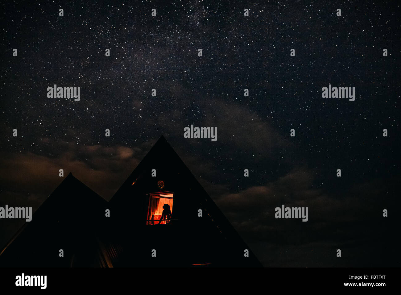 Woman Looking At Sky Night in the window Stock Photo - Alamy
