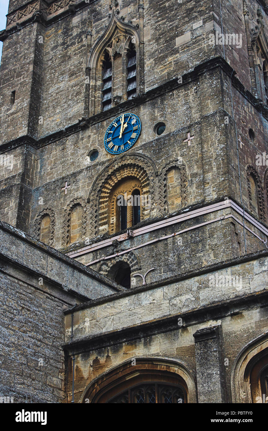Church clock tower with blue clock face in the classic style in England ...