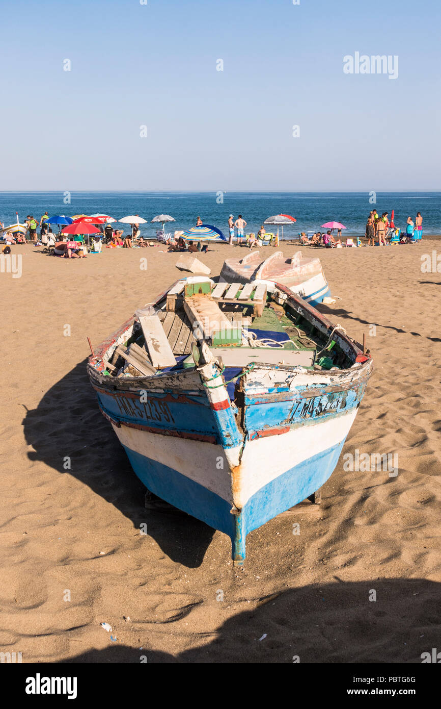 Old traditional wooden fishing boat in sand on beach at mediterranean ...
