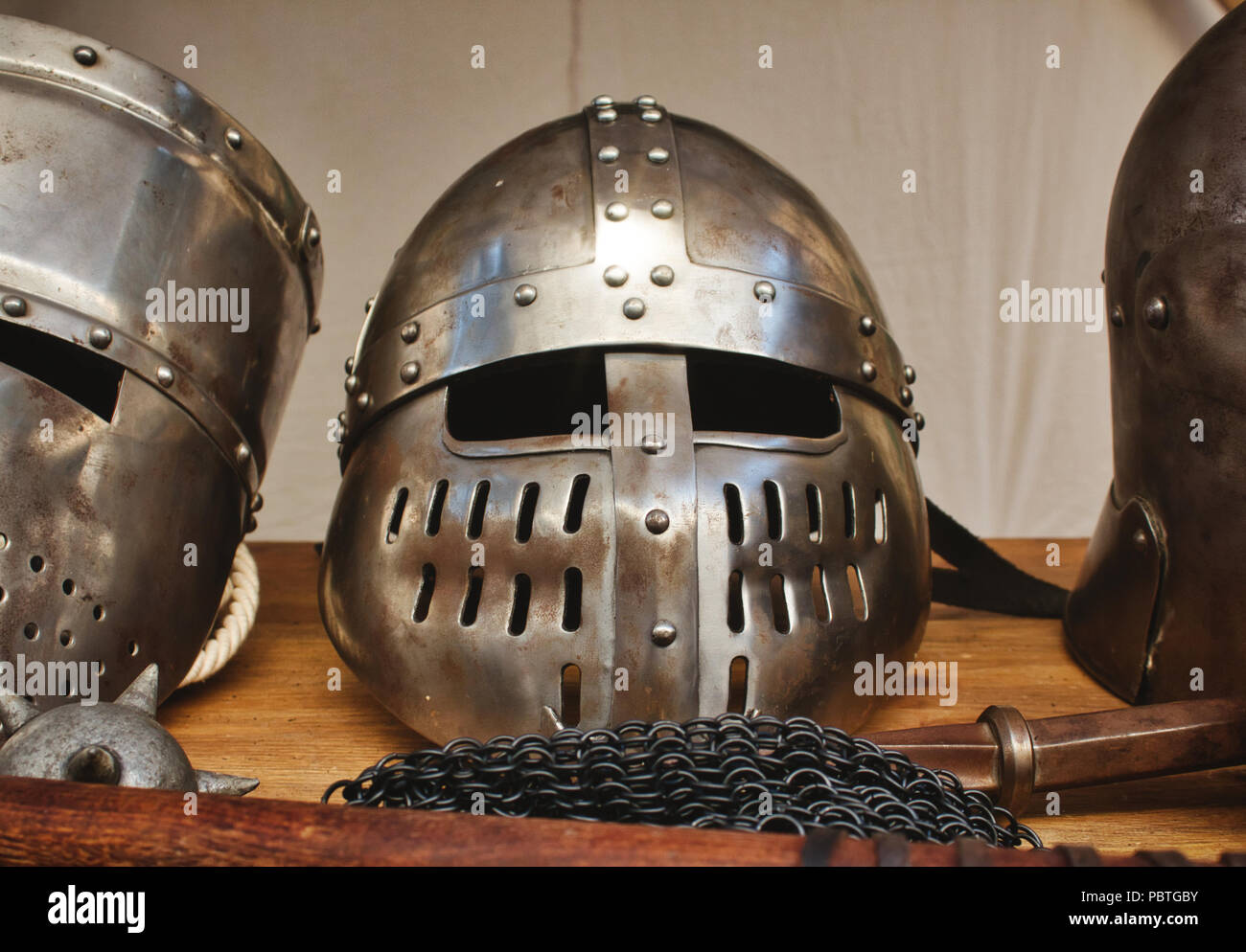 Shiny metal helmets of medieval knights with traditional weapons at a ...