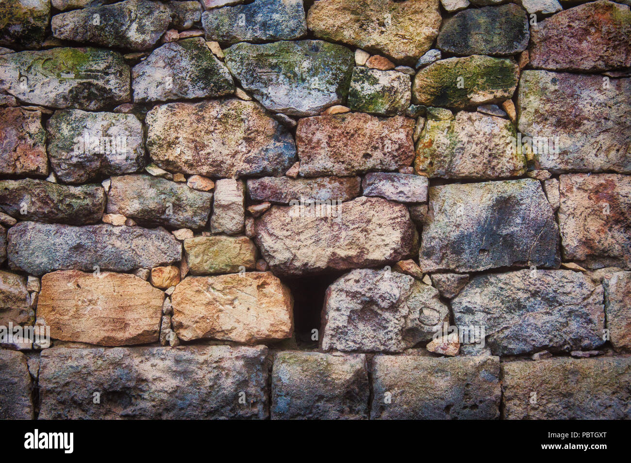 Old rustic stone wall with varied colors and sizes and textures Stock ...