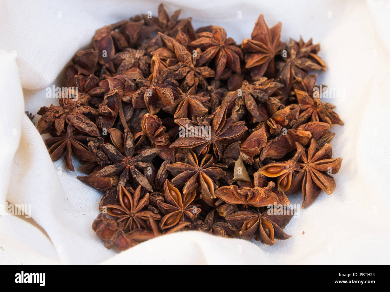 Star anise in a white cloth on display at a market stall Stock Photo ...