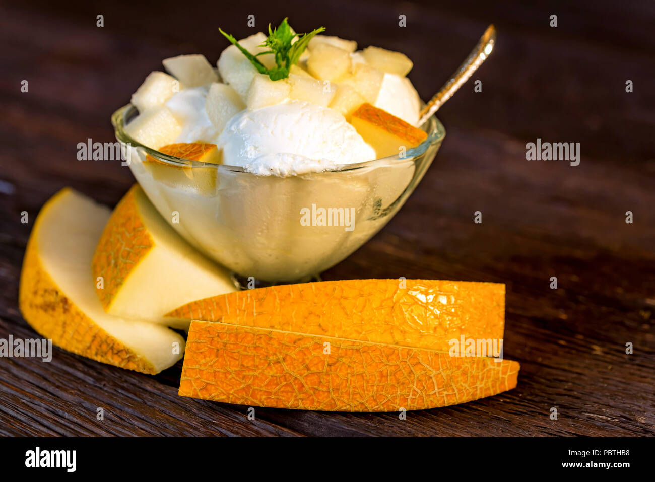 Vanilla ice cream with pieces of fresh melon close Stock Photo - Alamy
