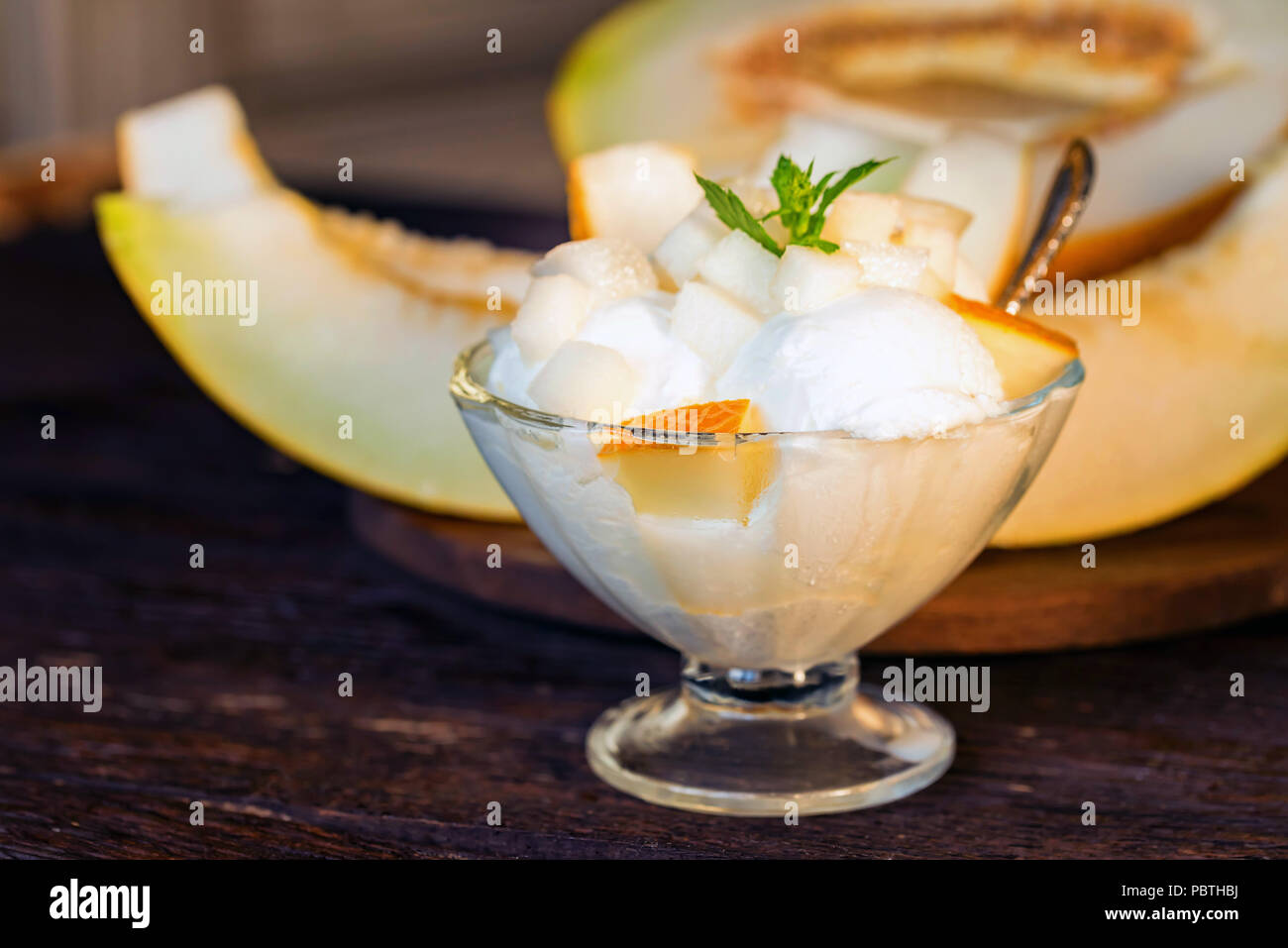 Vanilla ice cream with pieces of fresh melon close Stock Photo - Alamy