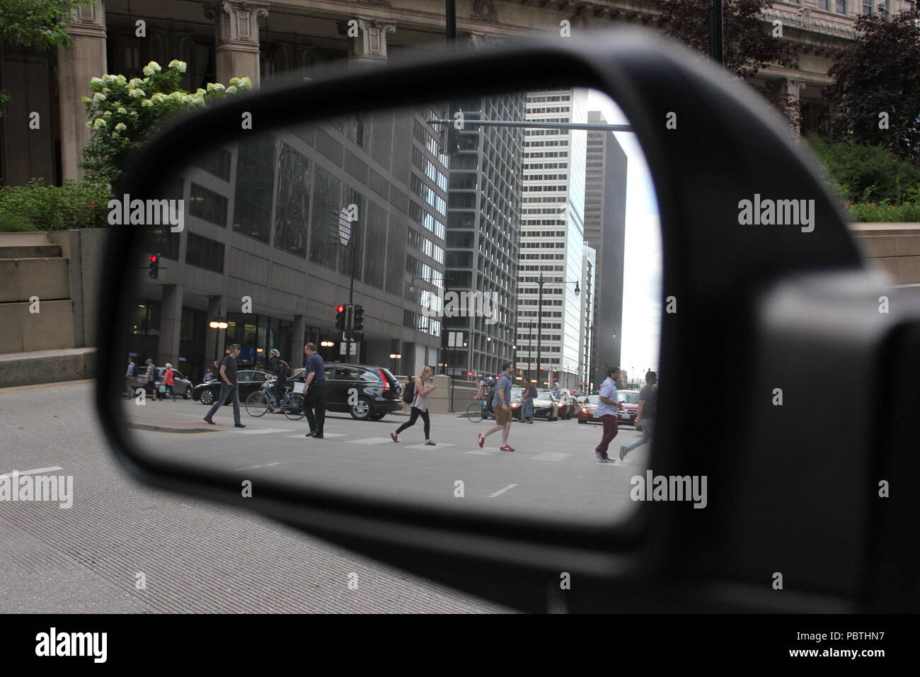 Commuter pedestrians crossing the street at the crosswalk scene as seen ...