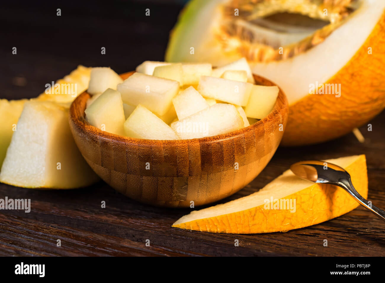 Chopped melon in a wooden bowl close Stock Photo - Alamy