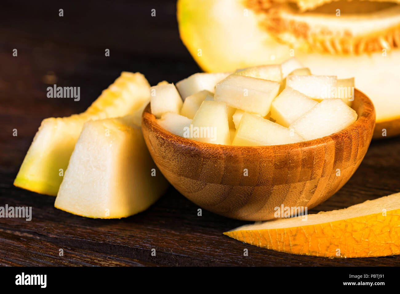 Chopped melon in a wooden bowl close Stock Photo - Alamy