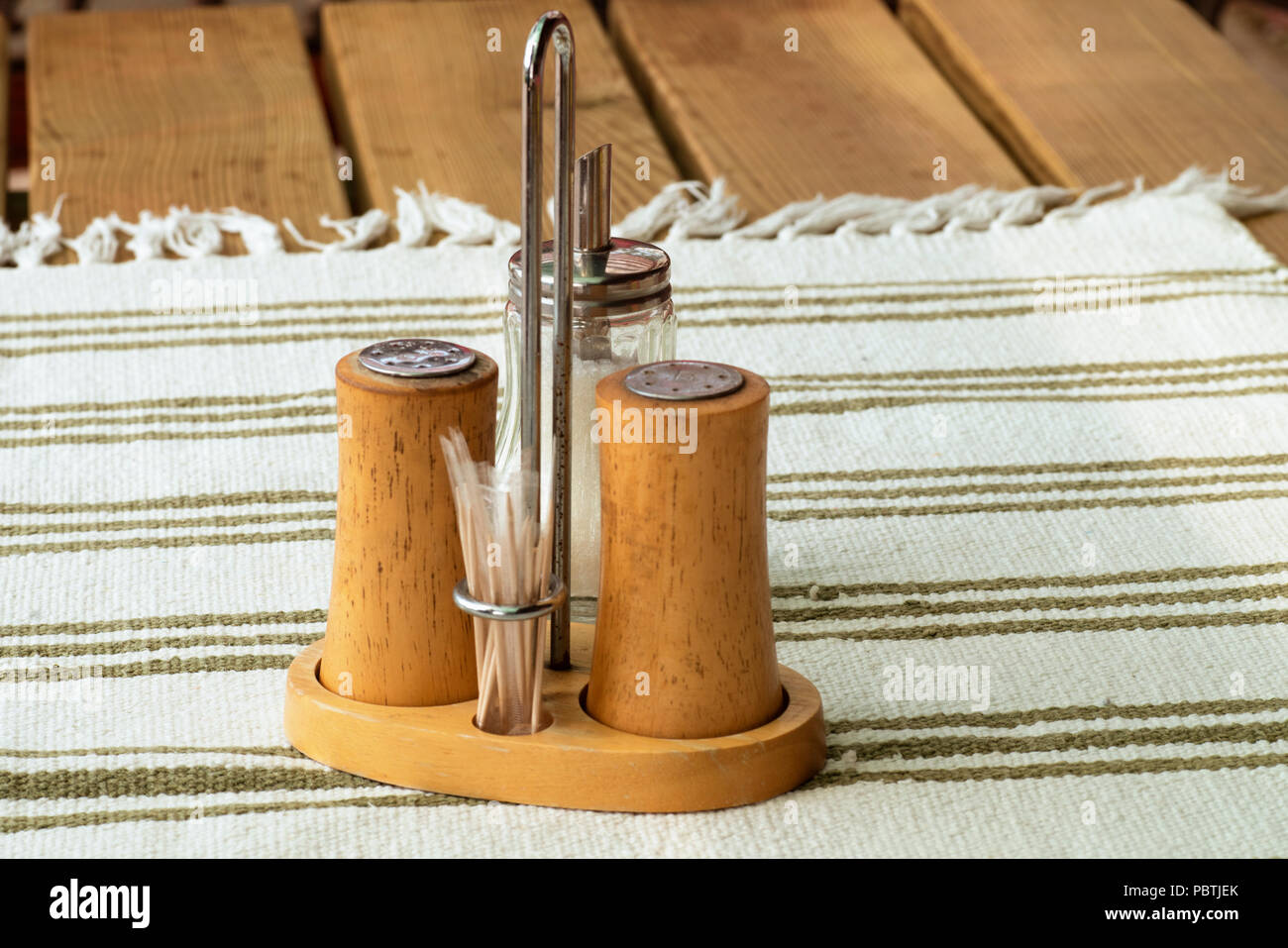 Salt and Pepper shaker on a wooden table Stock Photo - Alamy