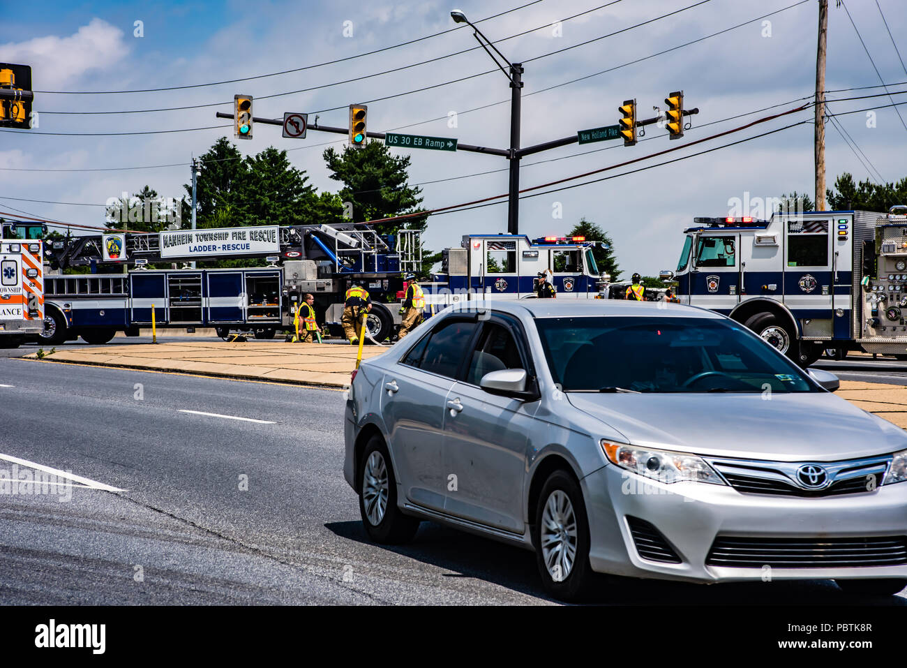 Overturned car at traffic accident scene near major highway on ramp ...