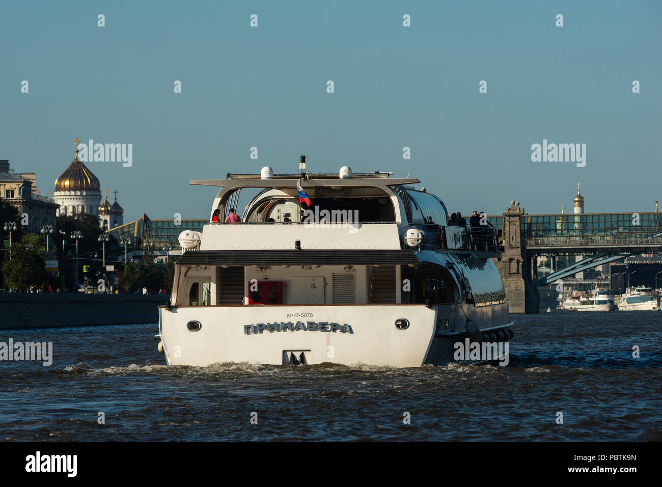 Modern leisure boat goes down the Moscow-river. Cathedral of Christ the ...