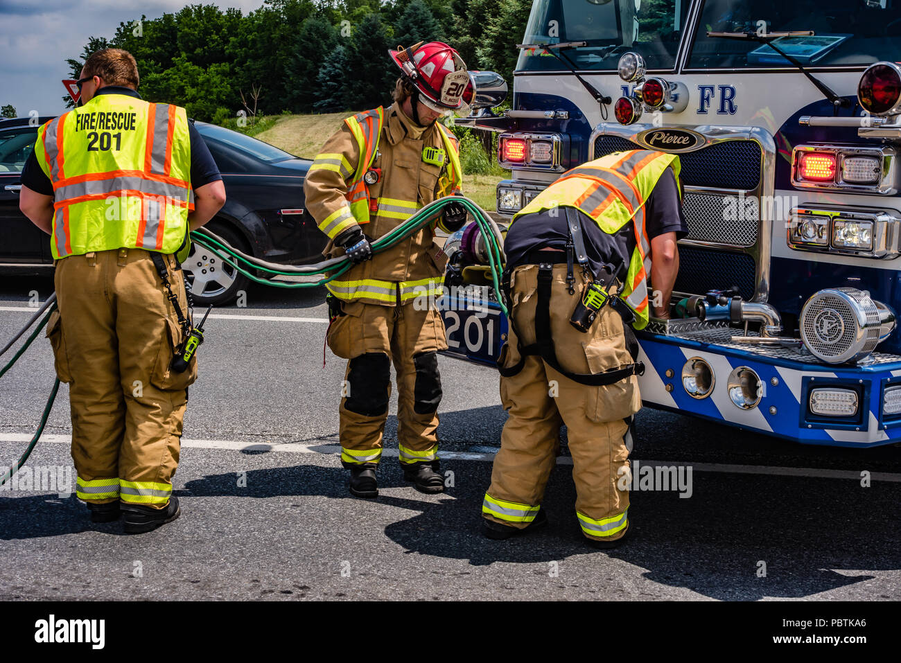 Traffic accident scene. Firemen and EMT personnel Stock Photo - Alamy