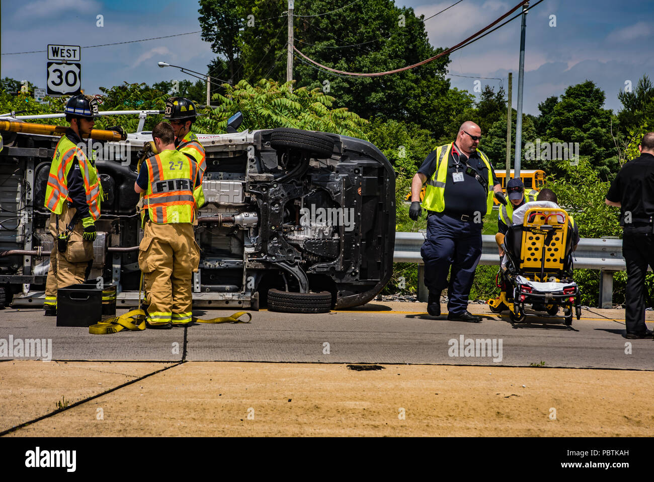 Overturned car at traffic accident scene near major highway on ramp ...