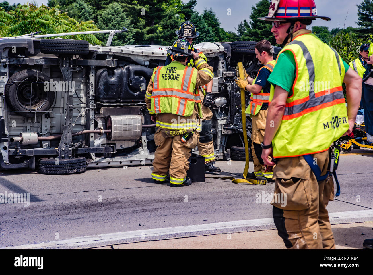 Traffic accident scene. Firemen and EMT personnel Stock Photo - Alamy