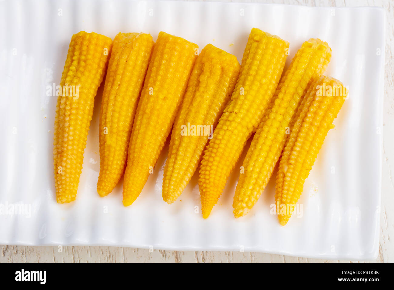 Tasty salty small pickled corn Stock Photo - Alamy
