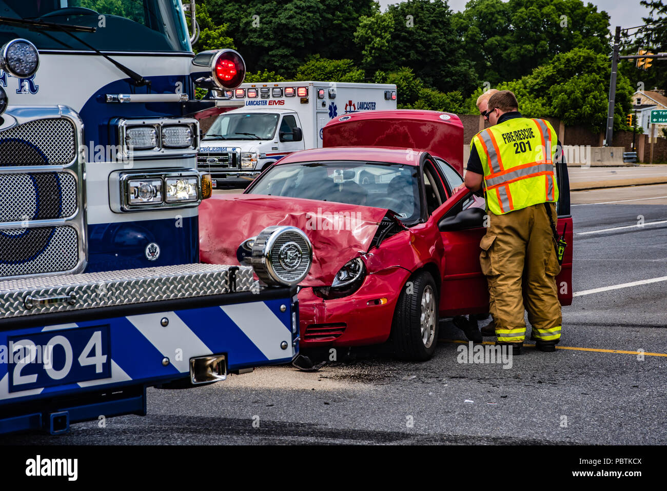 Traffic accident scene. Firemen and EMT personnel Stock Photo - Alamy