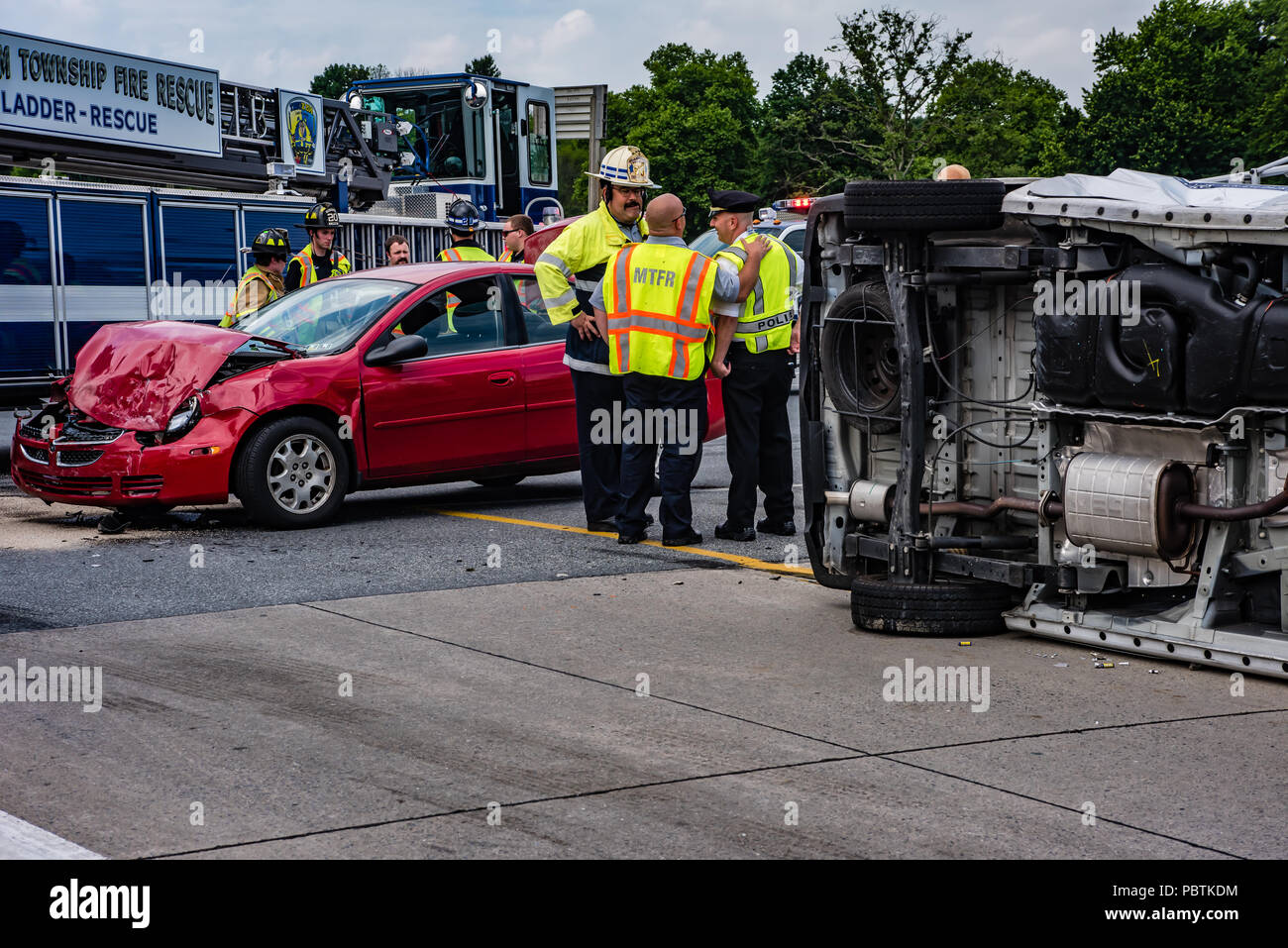 Overturned car at traffic accident scene near major highway on ramp ...