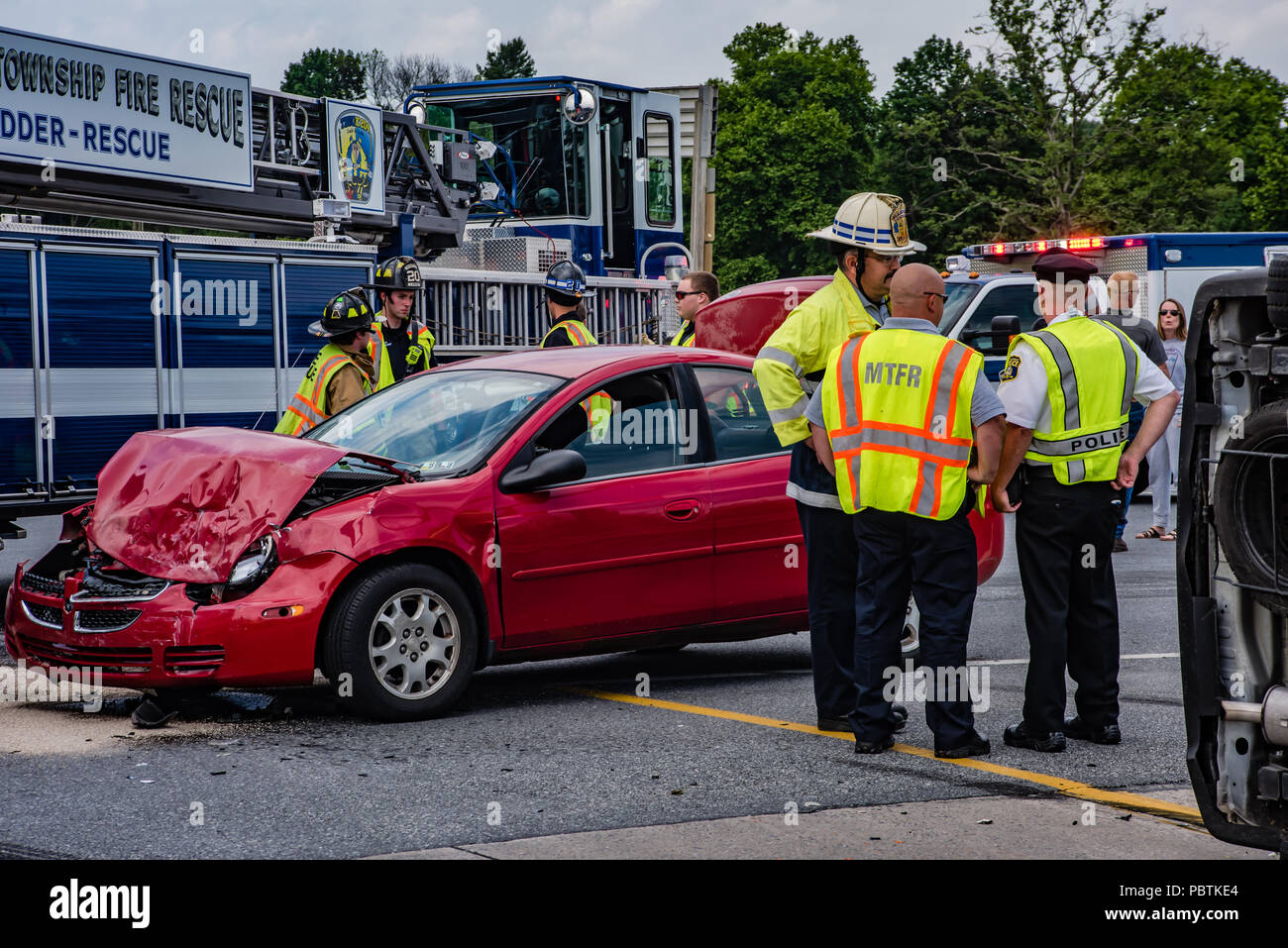 Overturned car at traffic accident scene near major highway on ramp ...