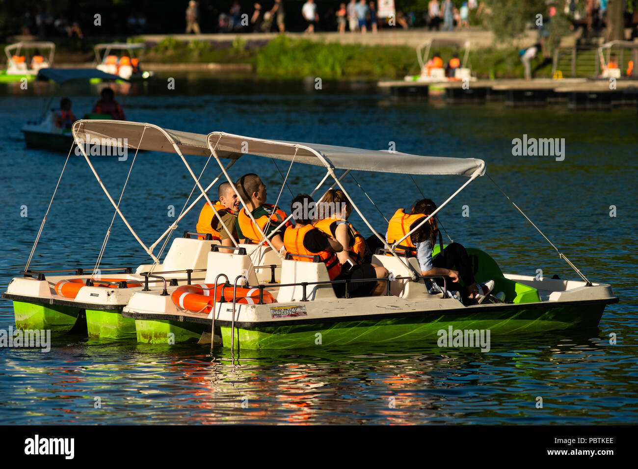 Moscow. Unidentified young people use a hydro-cycle or a pedal boat at ...