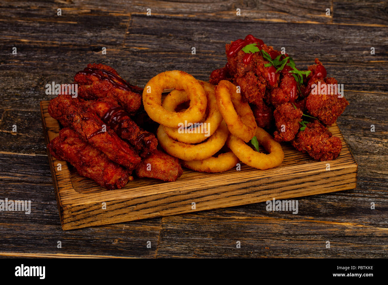 Chicken wings, leg and onion fry plate Stock Photo - Alamy