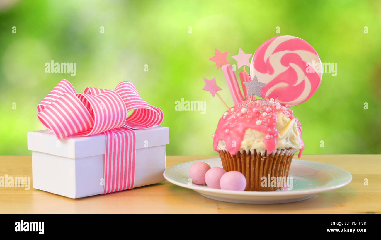 Pink theme colorful novelty cupcake decorated with candy and large ...