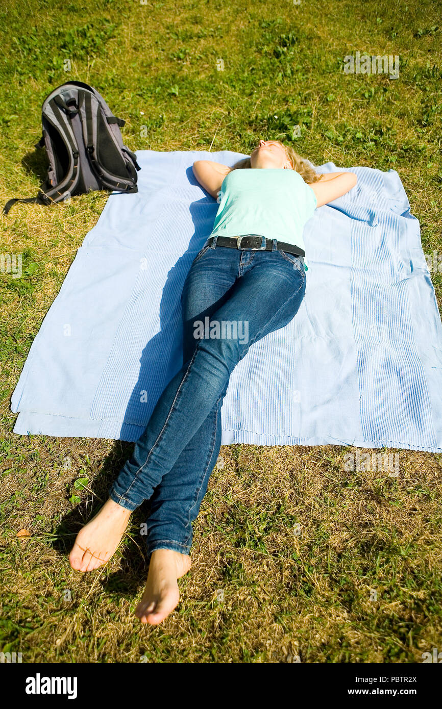 A woman is resting on the ground. Human and nature Stock Photo - Alamy