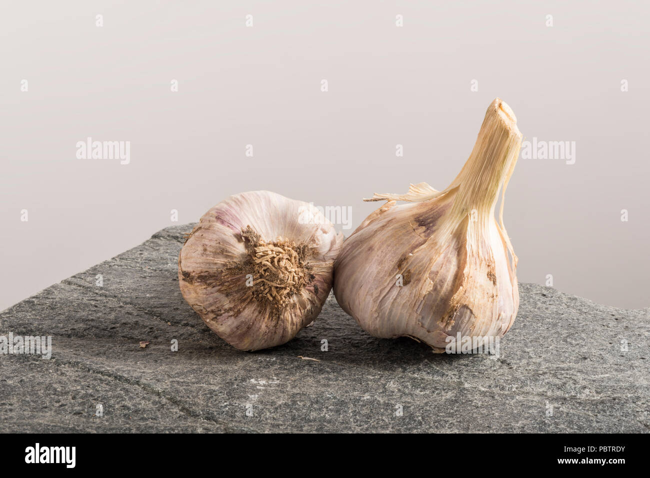 Fresh garlic on stone background Stock Photo - Alamy